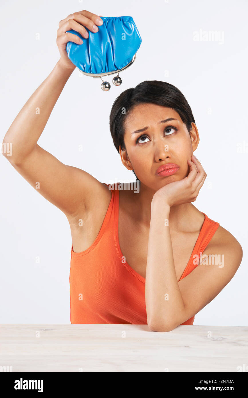 Woman holding empty purse hi-res stock photography and images - Alamy