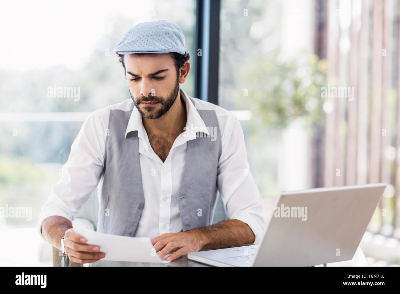 Focused man looking at document Stock Photo - Alamy
