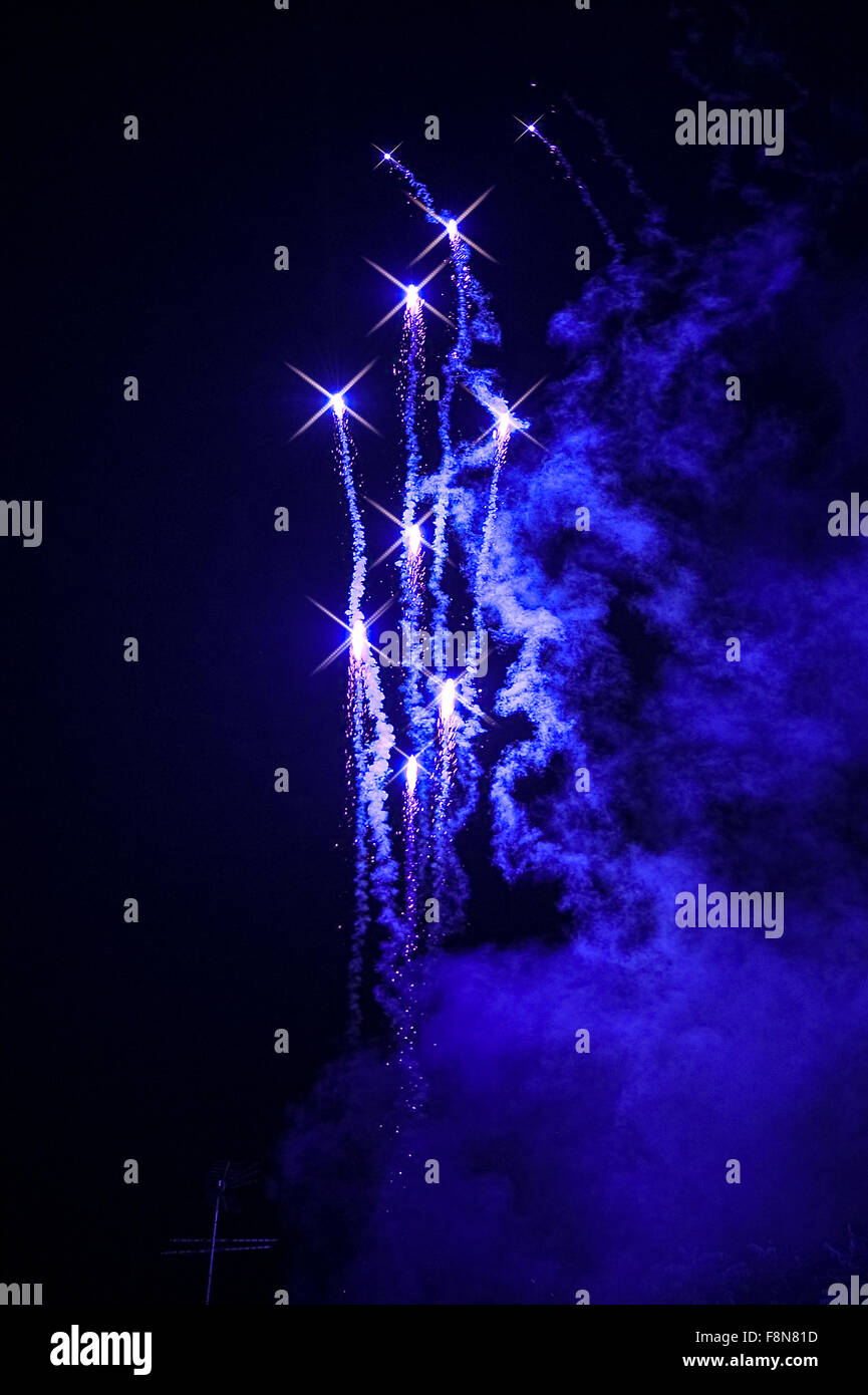 Blue glow with fireworks at night Stock Photo - Alamy