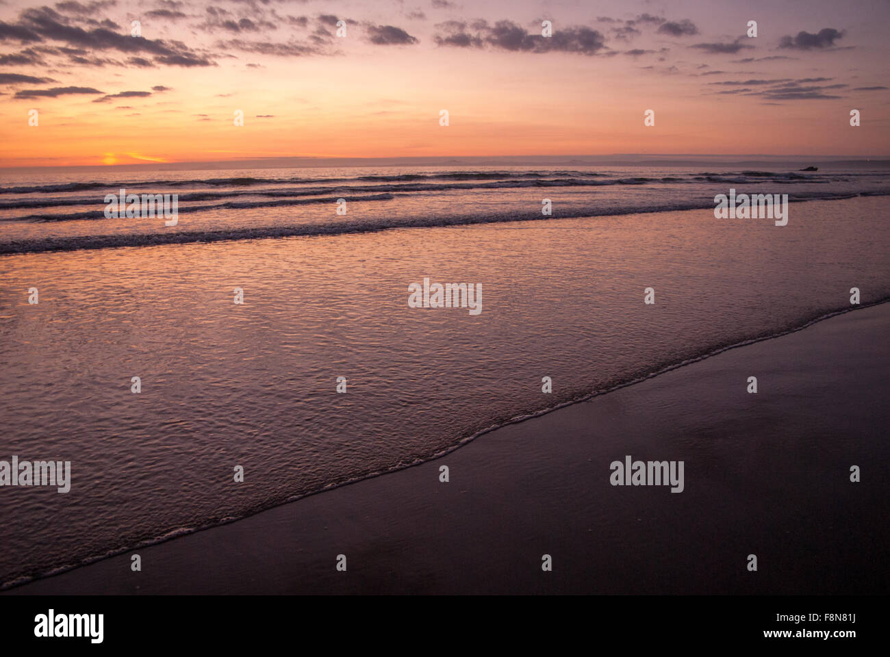 Red sunset over water on a beach Stock Photo - Alamy