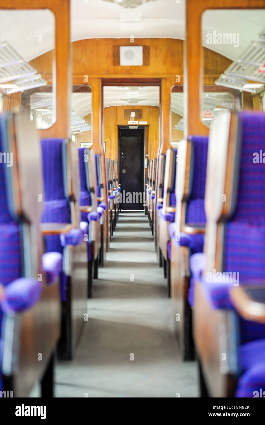 Railway train carriage walk way with chairs Stock Photo - Alamy