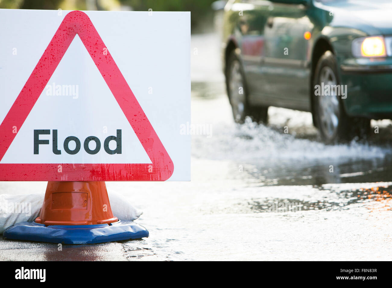 Warning Traffic Sign On Flooded Road With Cars Stock Photo - Alamy