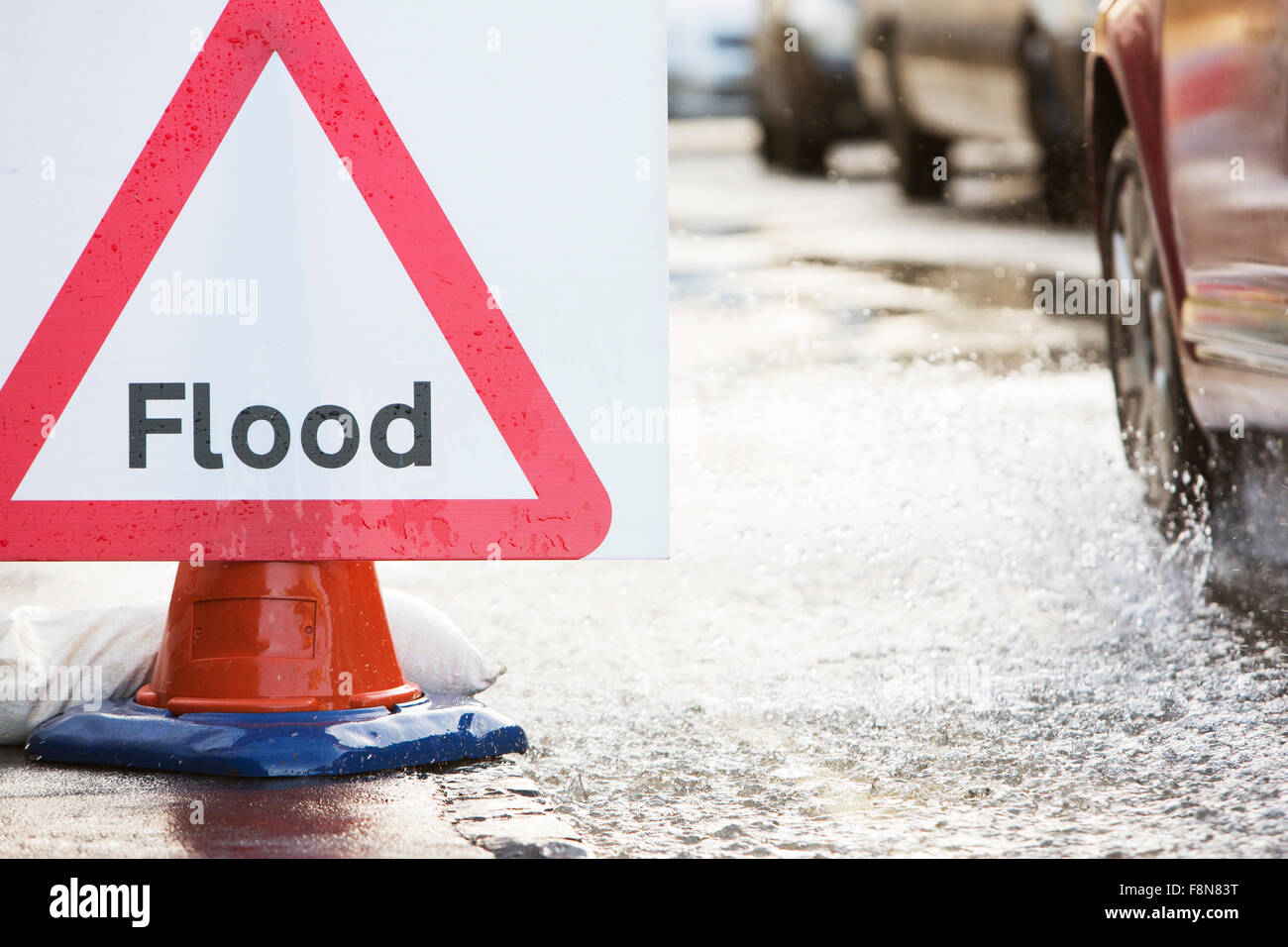 Warning Traffic Sign On Flooded Road With Cars Stock Photo - Alamy