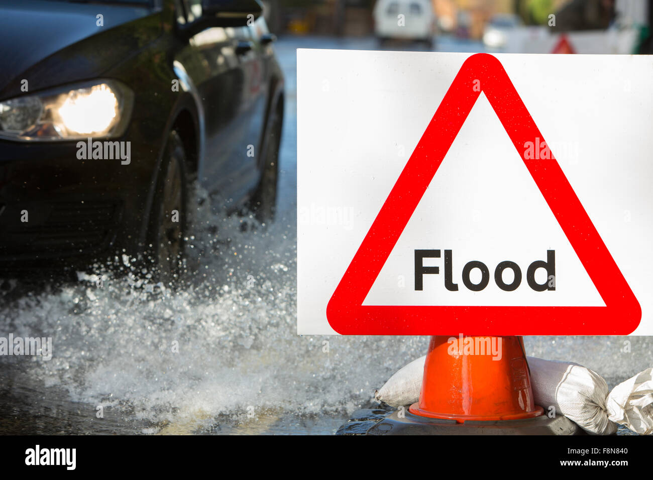 Warning Traffic Sign On Flooded Road With Cars Stock Photo - Alamy