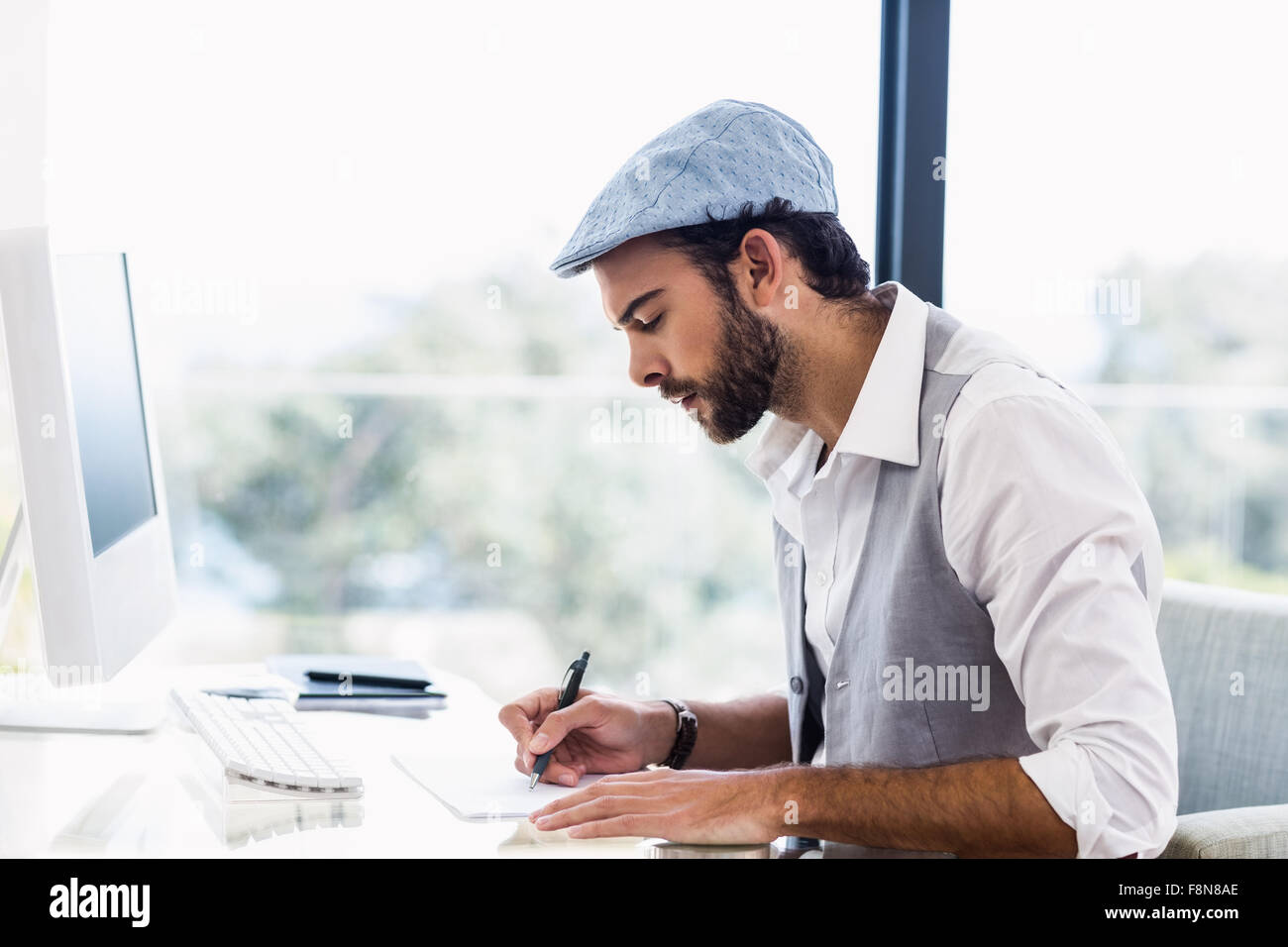 Side view of man taking notes Stock Photo - Alamy