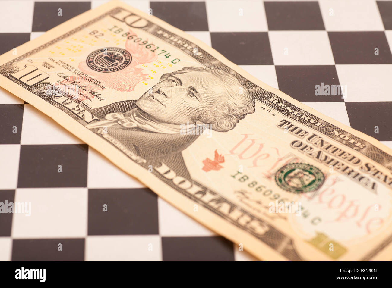 dollar bill on a chess board Stock Photo - Alamy