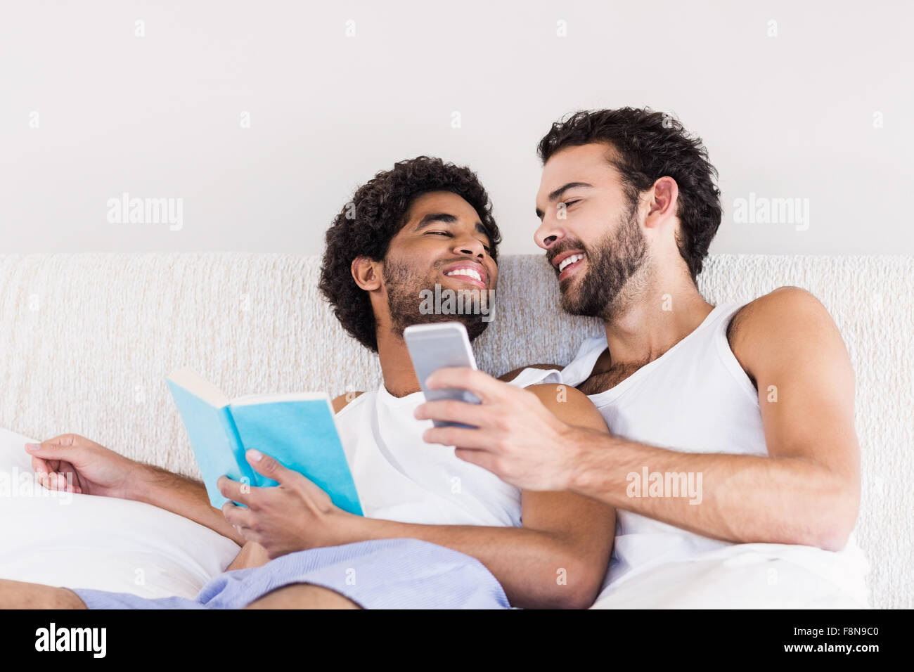 Happy gay couple cuddling on hi-res stock photography and images - Alamy