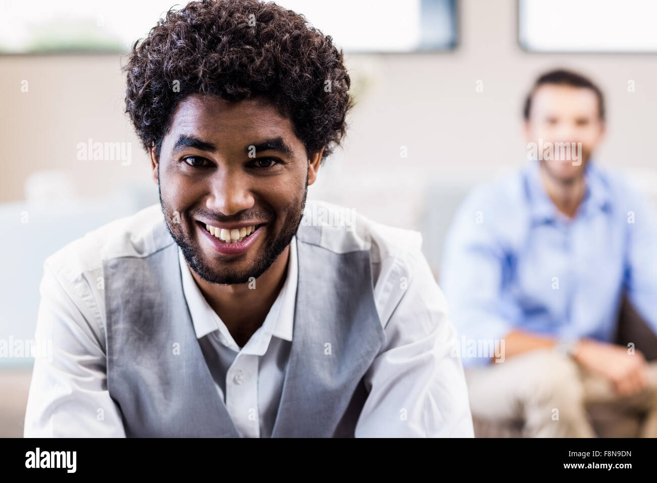 Handsome man smiling at the camera Stock Photo - Alamy