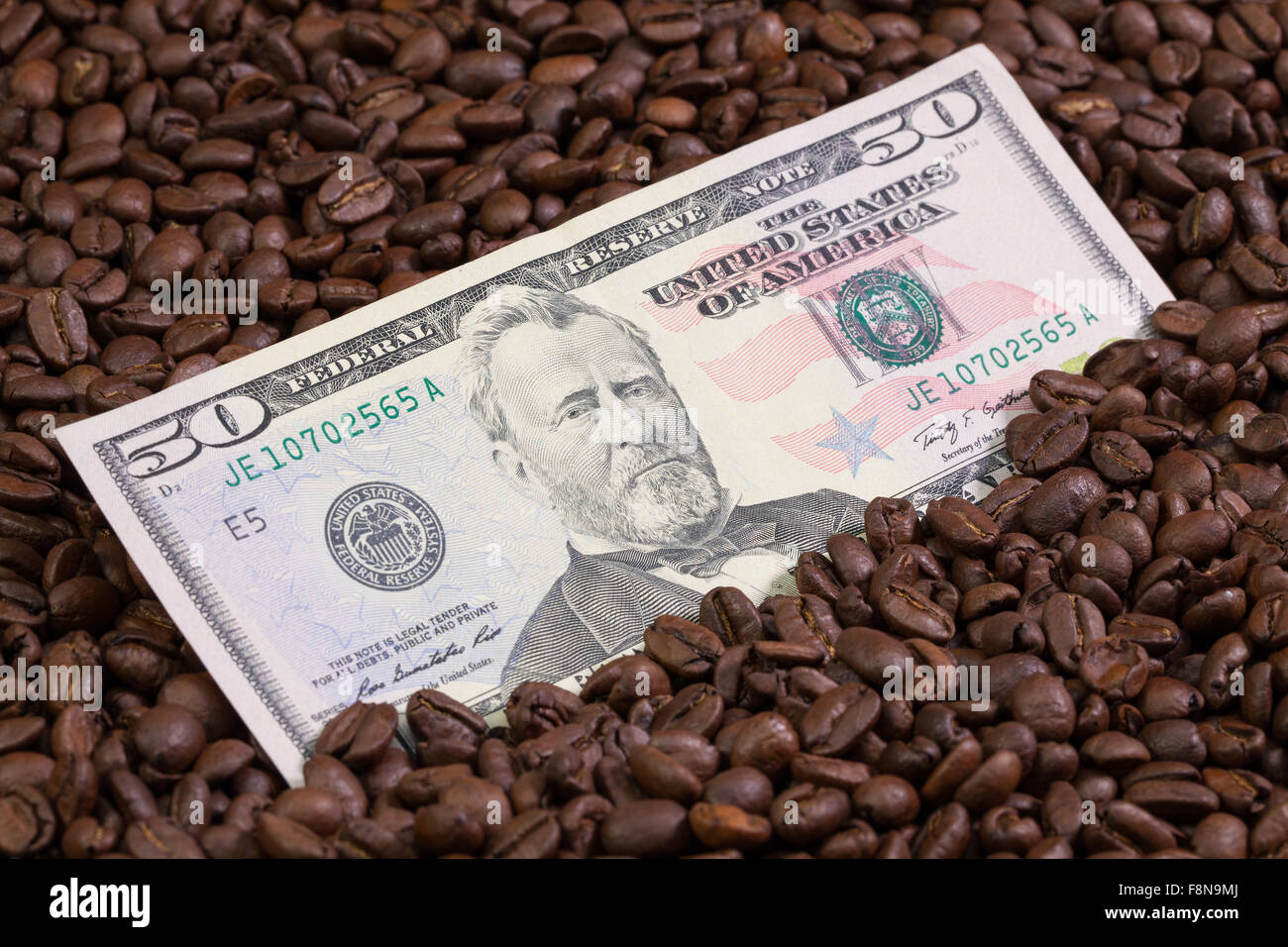 Coffee beans and US dollar banknote Stock Photo - Alamy