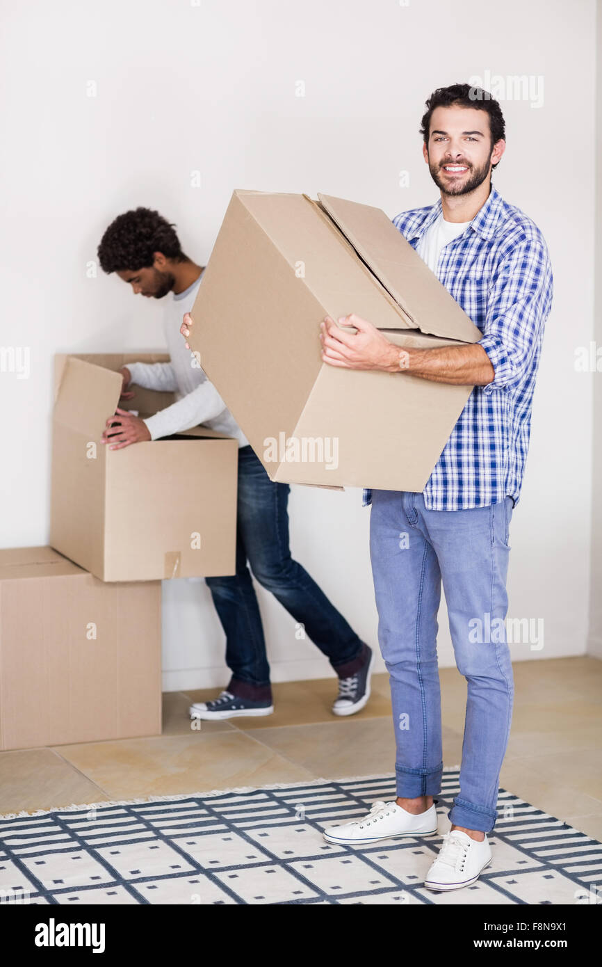 Happy gay couple holding big boxes Stock Photo - Alamy