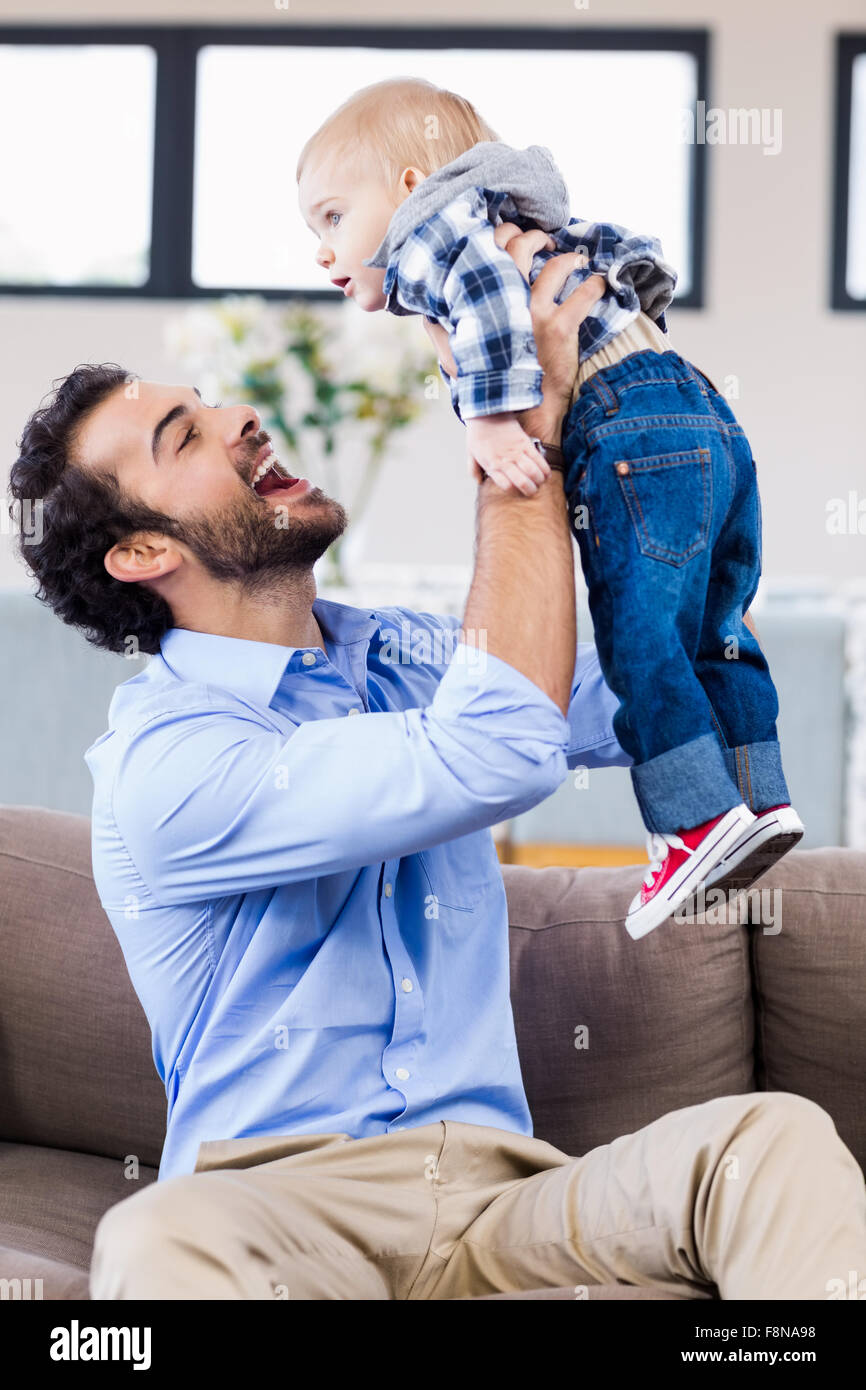 Handsome man playing with child Stock Photo - Alamy