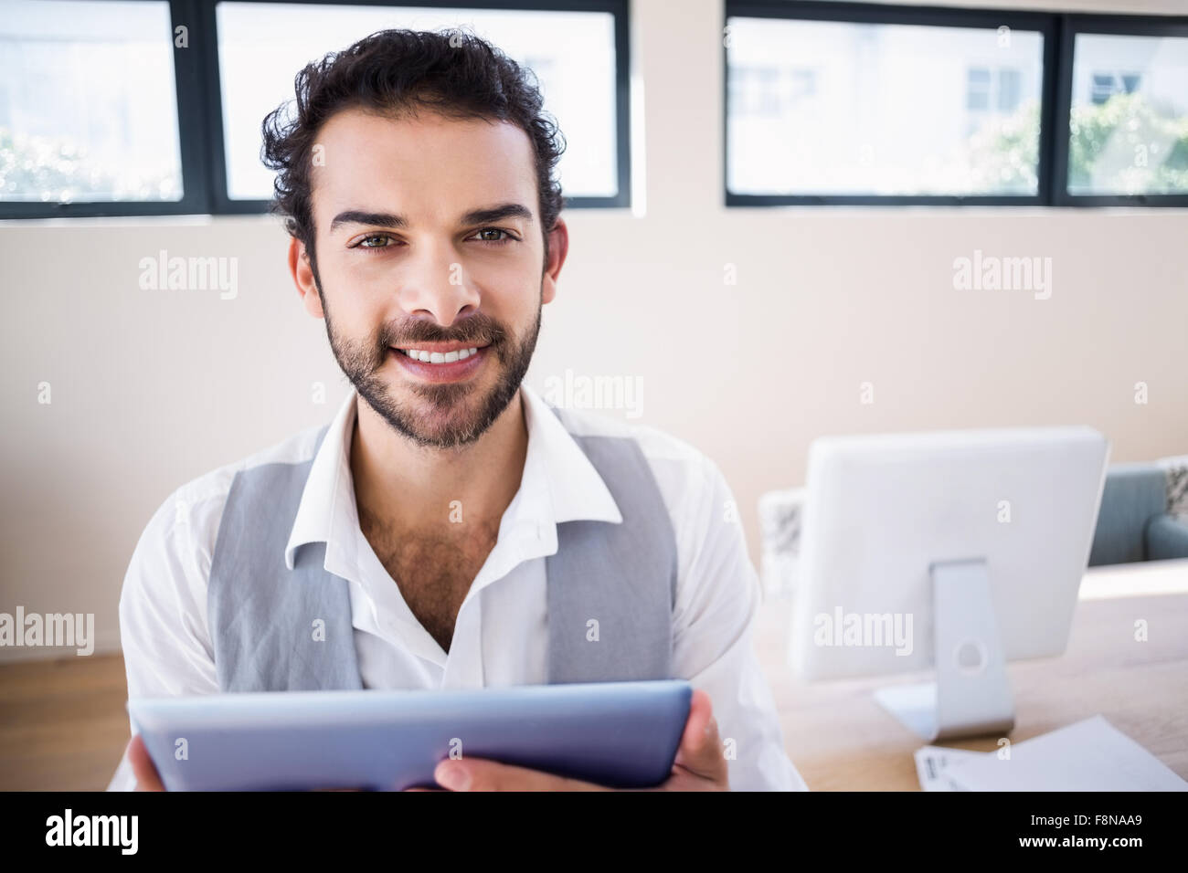 Portrait of smiling man holding tablet Stock Photo - Alamy
