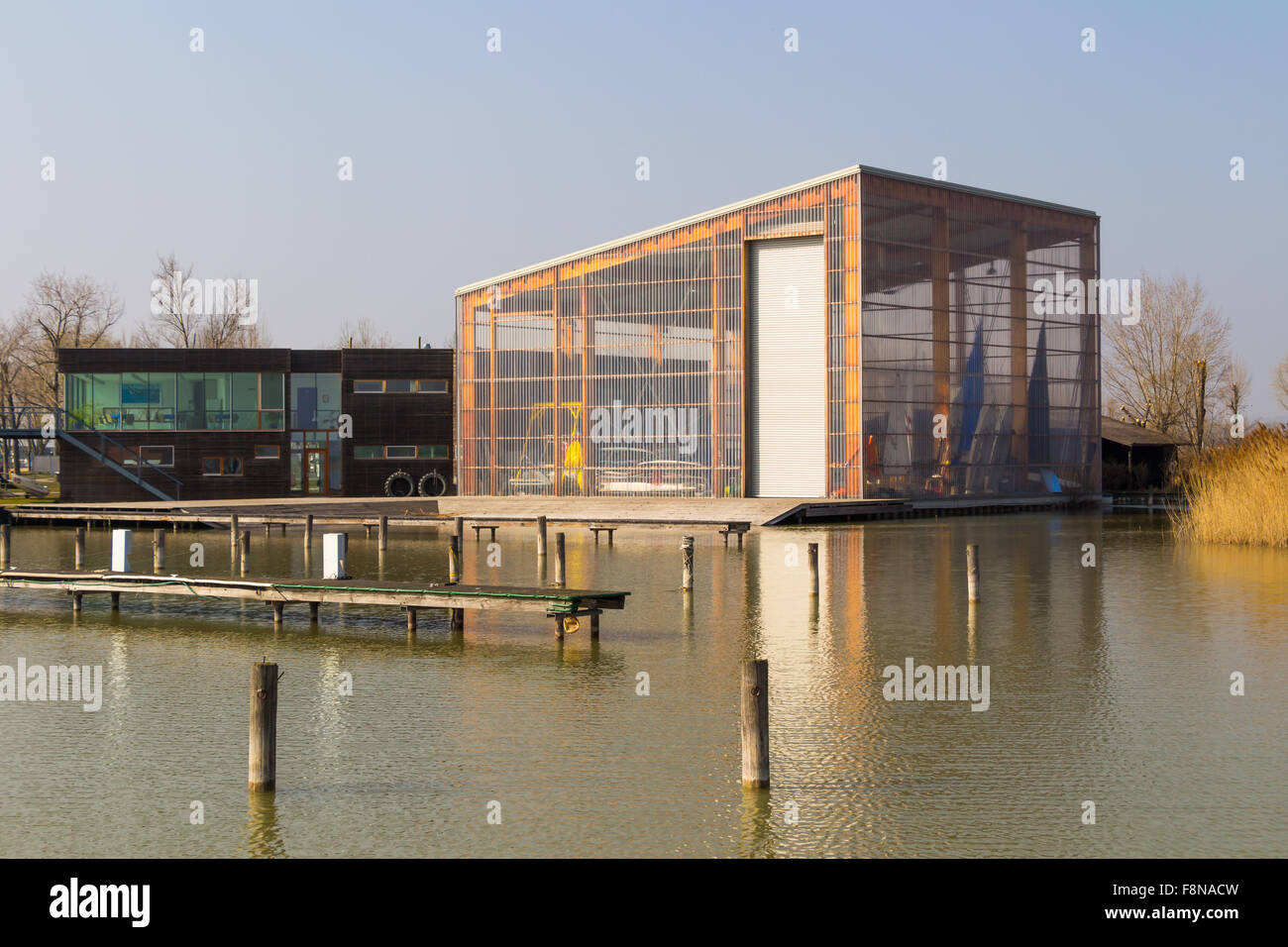 Lake house with pier and woods Stock Photo - Alamy