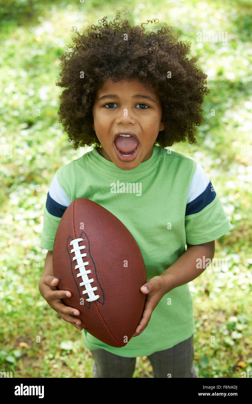 Kids Playing American Football In The Park