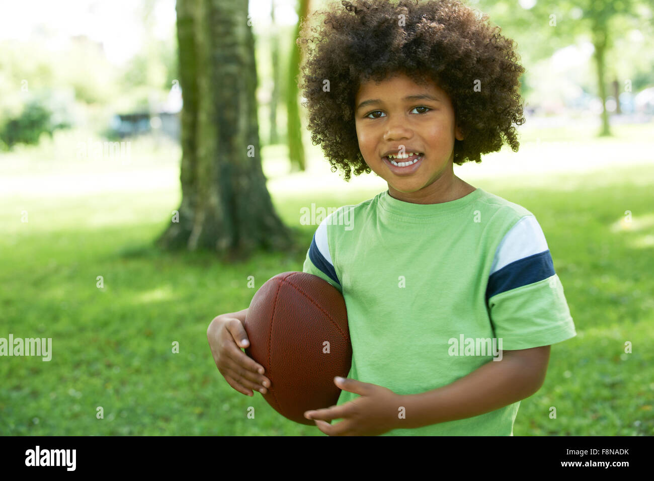 Kids Playing American Football In The Park