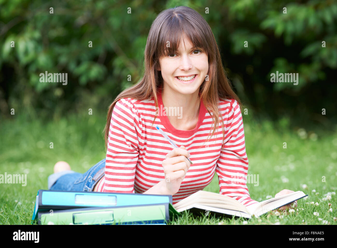 Young Female Student Studying In Park Stock Photo - Alamy