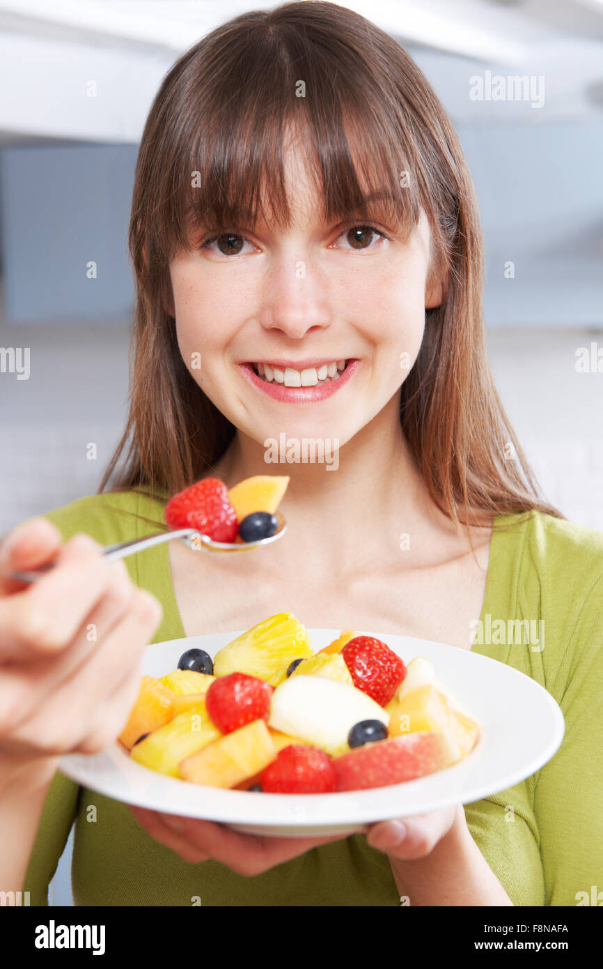 Young Woman Eating Bowl Of Fresh Fruit Stock Photo - Alamy