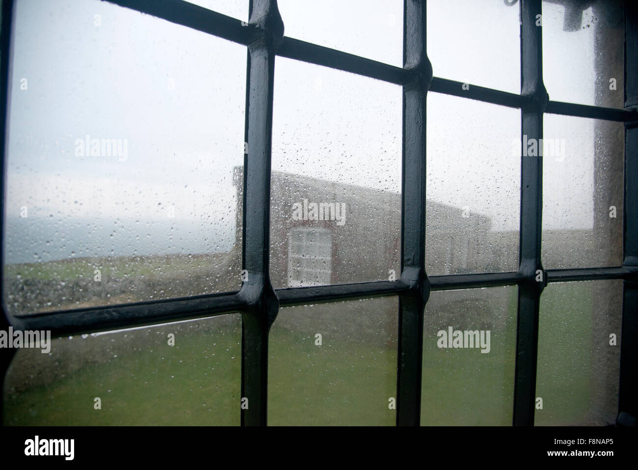 Looking out of Lower light window of Old Light lighthouse at the rain ...
