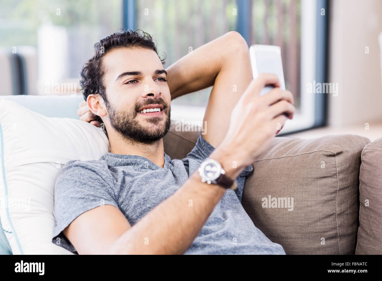 Handsome man using smartphone Stock Photo - Alamy