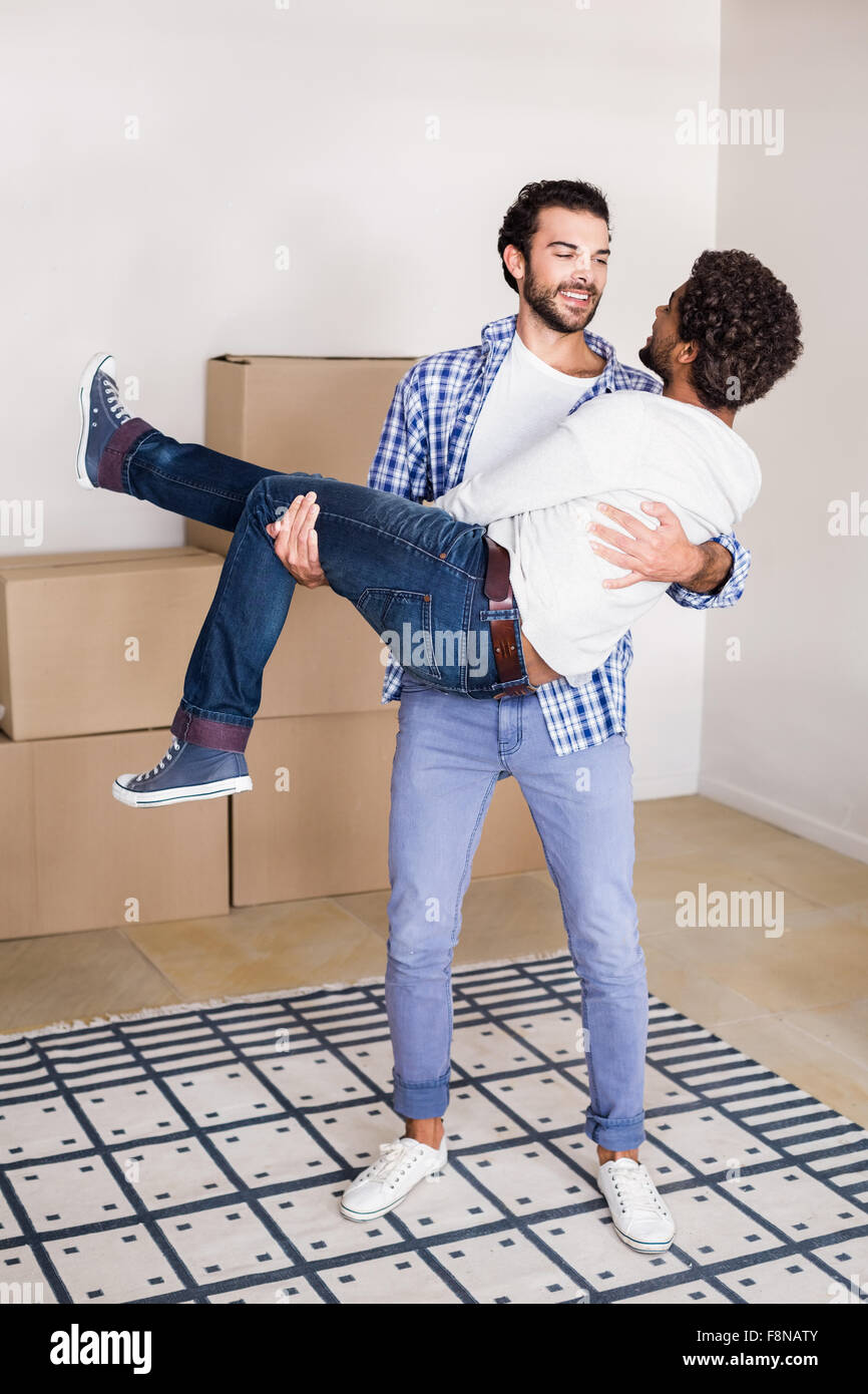 Smiling man picking up his partner Stock Photo - Alamy