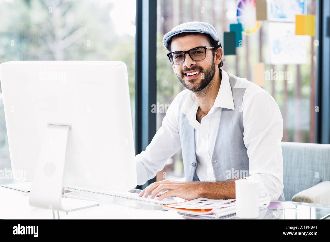 Smiling man working on computer Stock Photo - Alamy