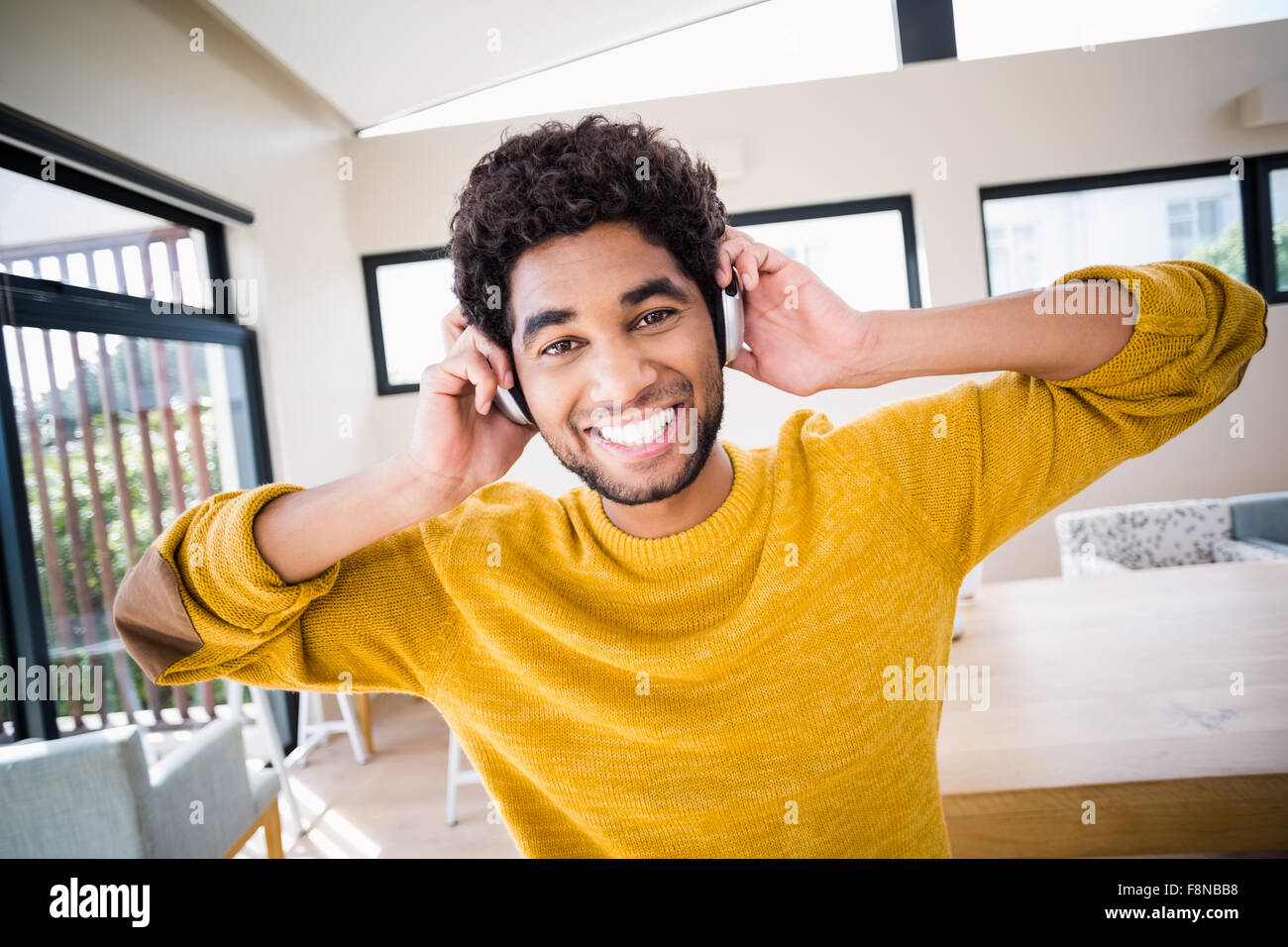 Portrait of smiling man using headphones Stock Photo - Alamy