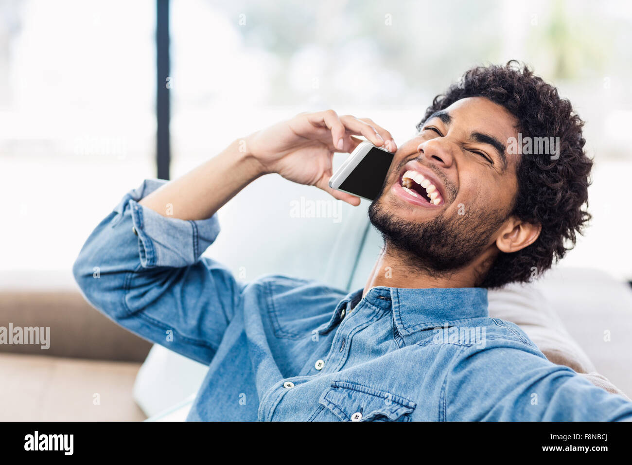 Handsome man on phone call laughing Stock Photo - Alamy