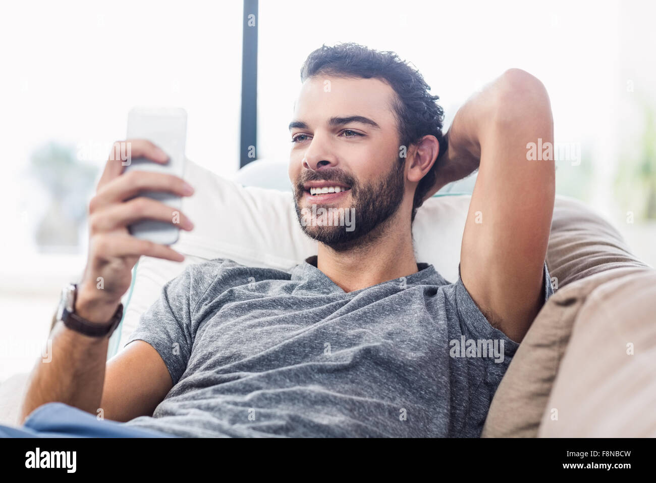 Attractive man using smartphone Stock Photo - Alamy