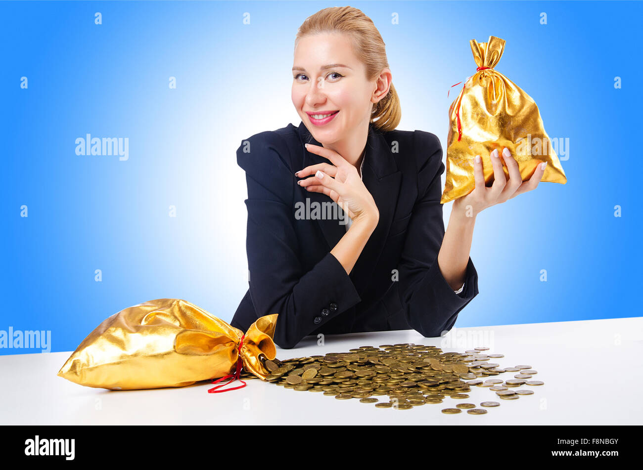 Woman with coins and golden sacks Stock Photo - Alamy