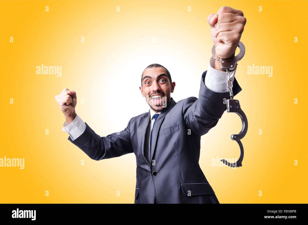 Funny businessman with handcuffs on white Stock Photo - Alamy