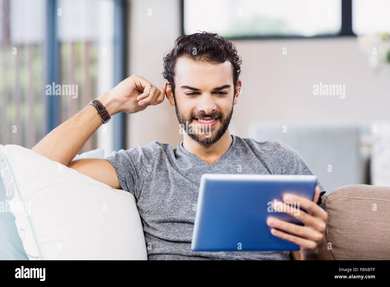 Handsome man using tablet Stock Photo - Alamy