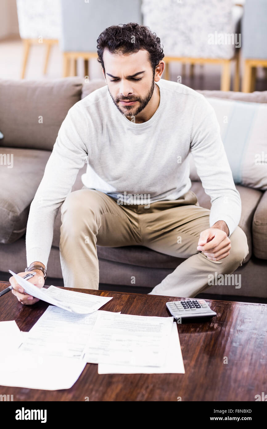 Paying bills man calculator hi-res stock photography and images - Alamy