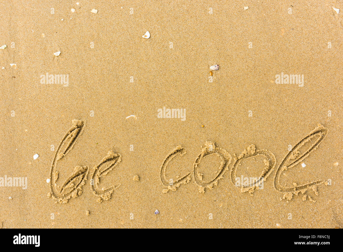 Be cool written on the beach. sand background Stock Photo - Alamy