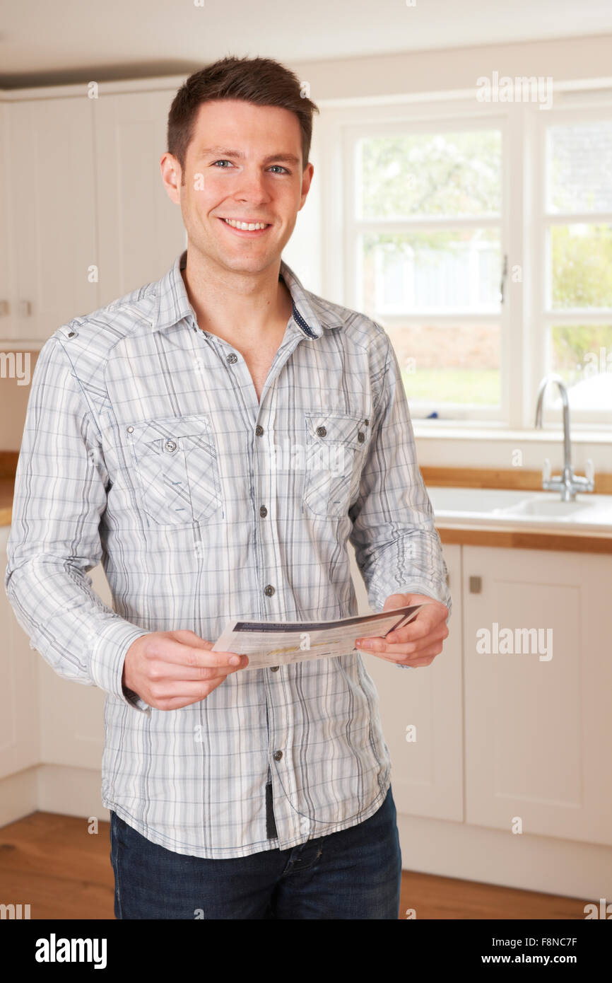Young Man Looking At Details For New House Stock Photo - Alamy
