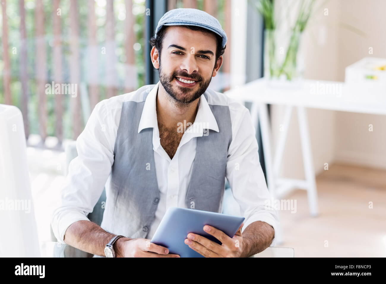 Handsome man holding tablet Stock Photo - Alamy