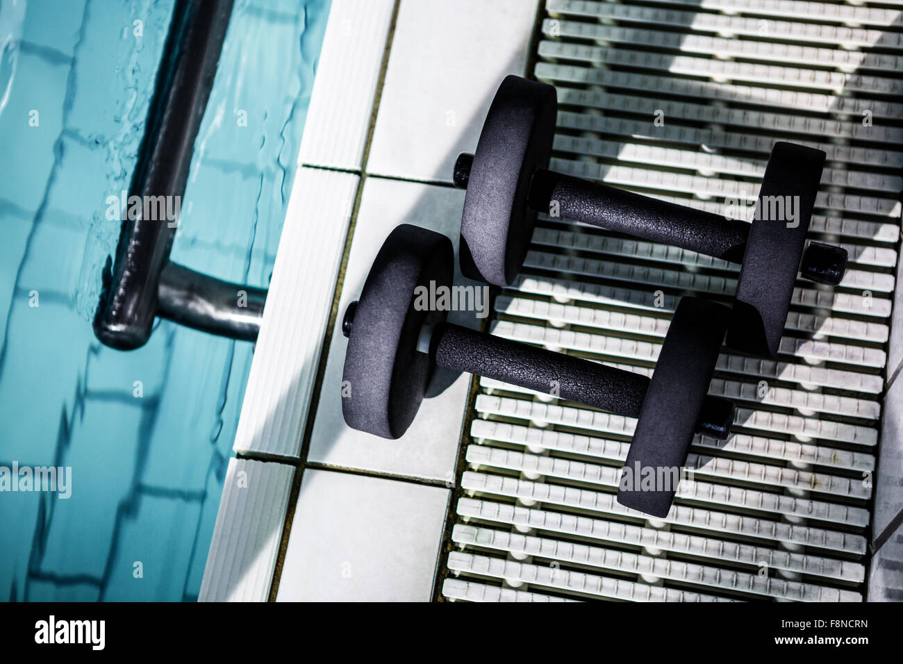 Foam dumbbells beside the pool Stock Photo - Alamy