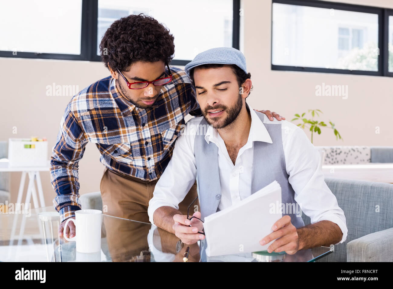Gay couple reading document Stock Photo - Alamy