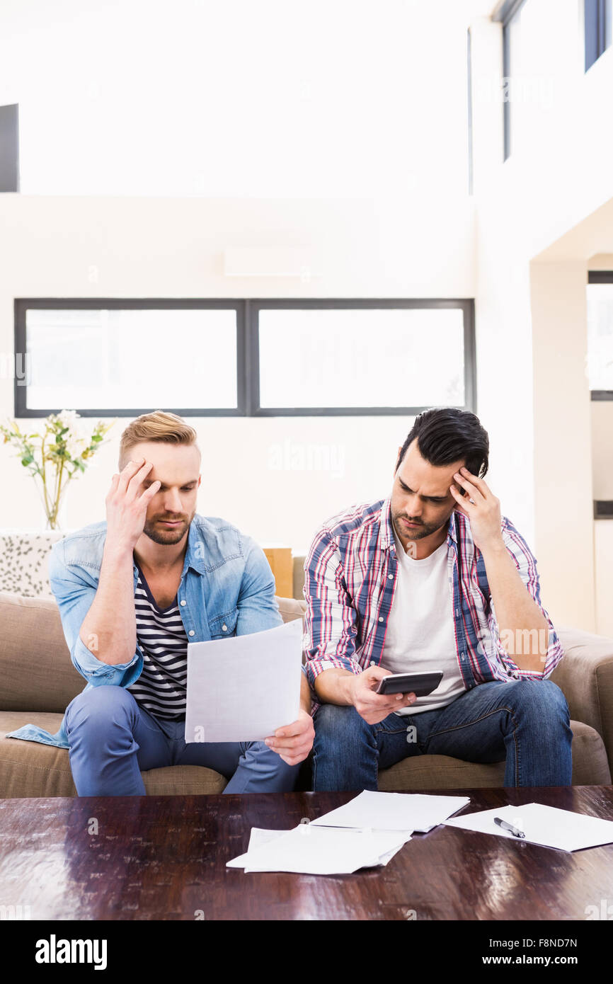 Gay couple worrying about their bills Stock Photo - Alamy
