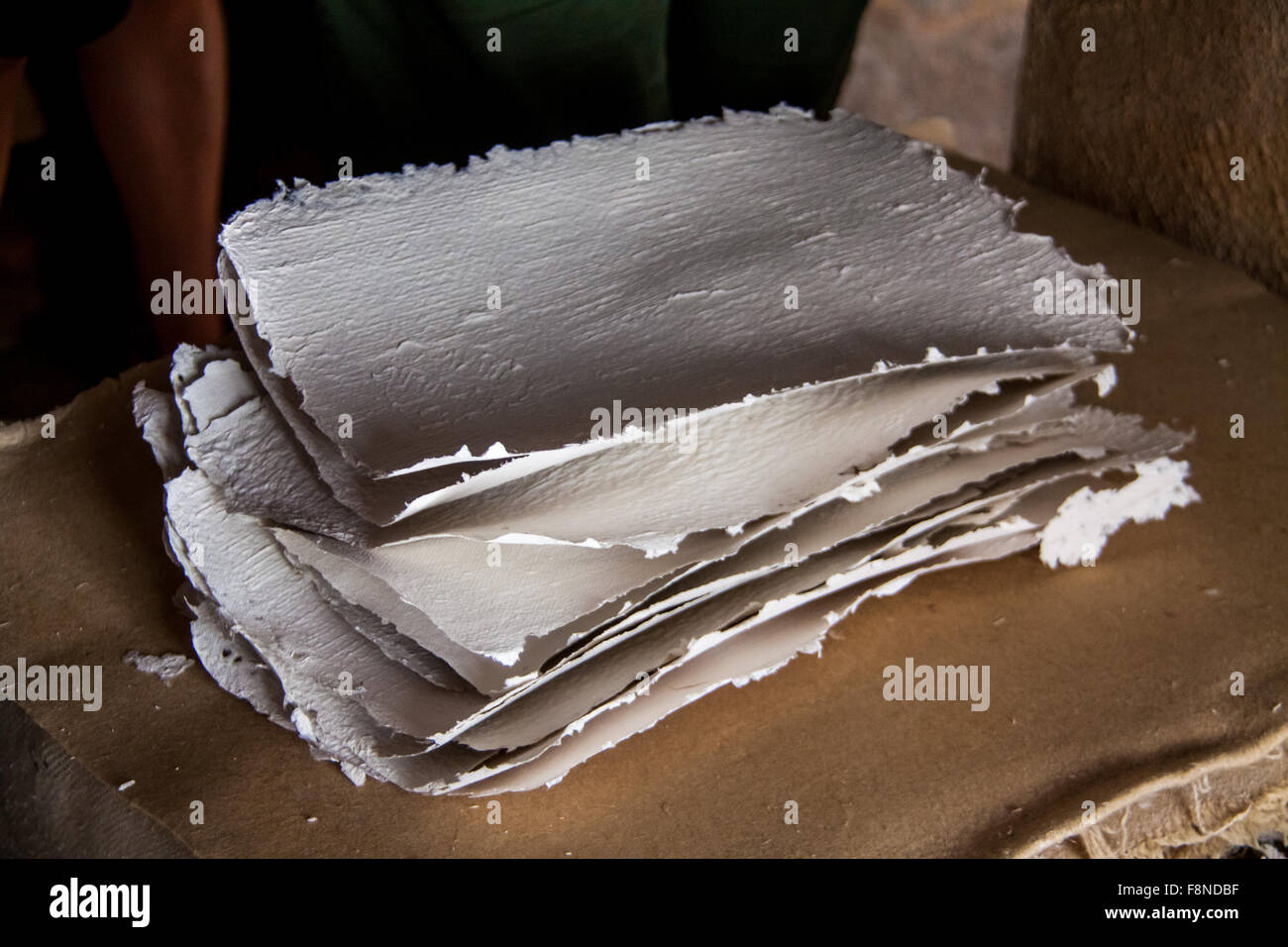 Stack of paper sheets in an ancient paper mill. Old traditional process ...