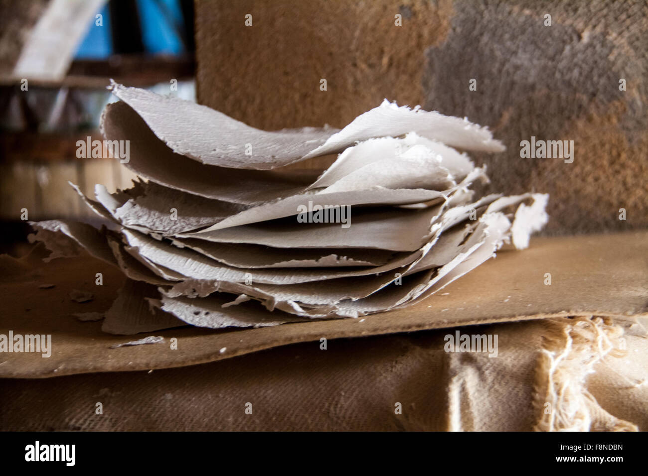 Stack of paper sheets in an ancient paper mill. Old traditional process ...