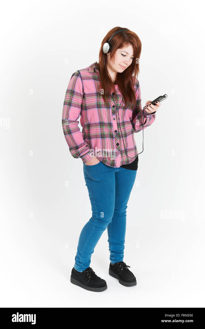 Full Length Cut Out Of Teenage Girl Listening To MP3 Player Stock Photo ...