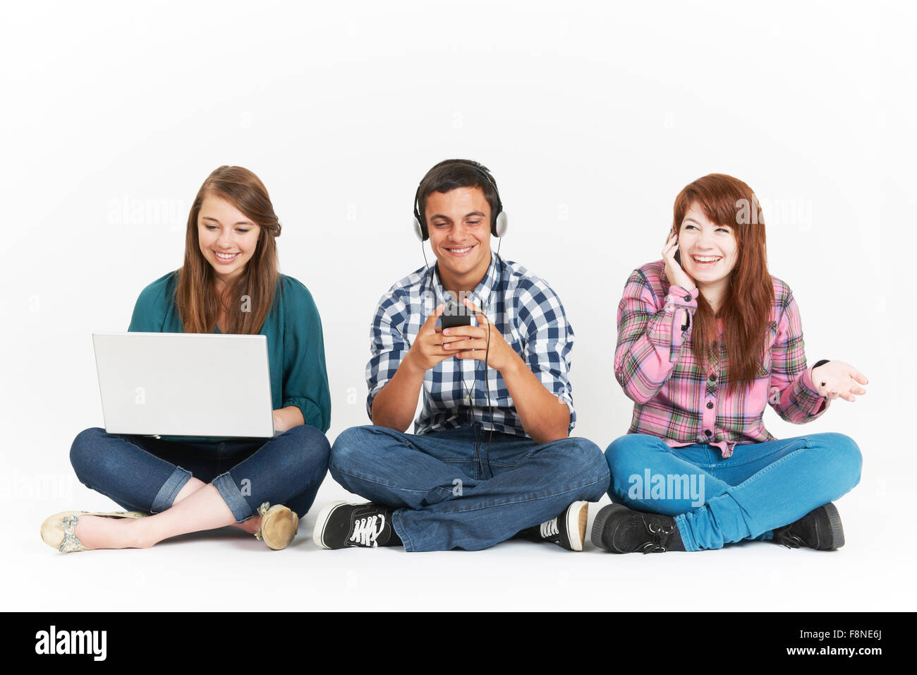 Teenagers Using Different Forms Of Digital Technology In Studio Stock ...