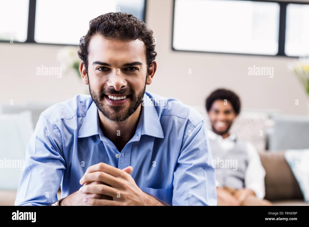 Handsome man sitting couch hi-res stock photography and images - Alamy