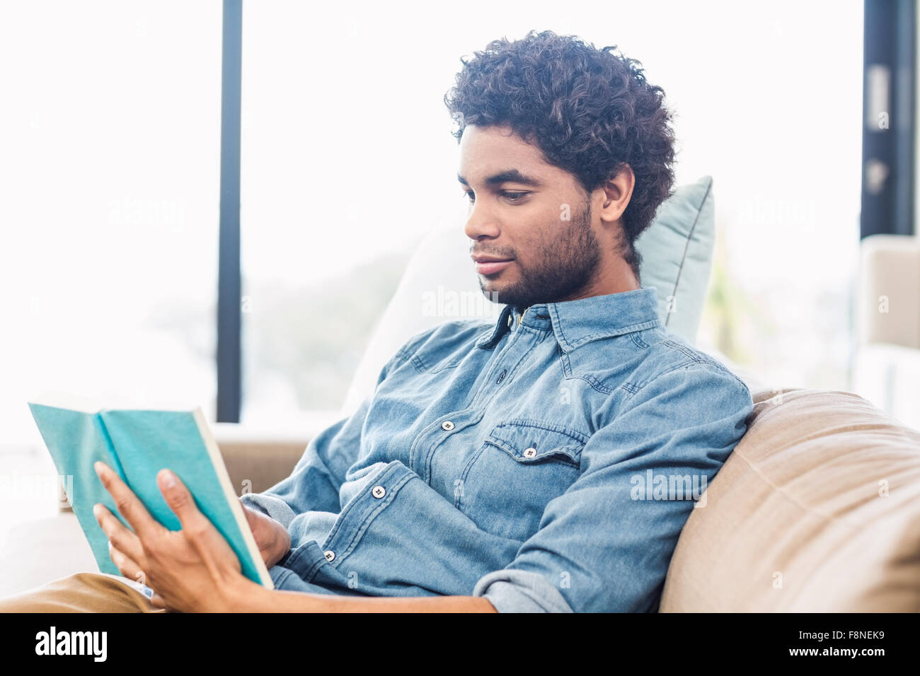 Handsome man reading book Stock Photo - Alamy