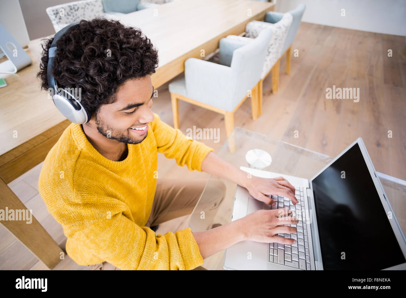 Happy man using headphones and laptop Stock Photo - Alamy