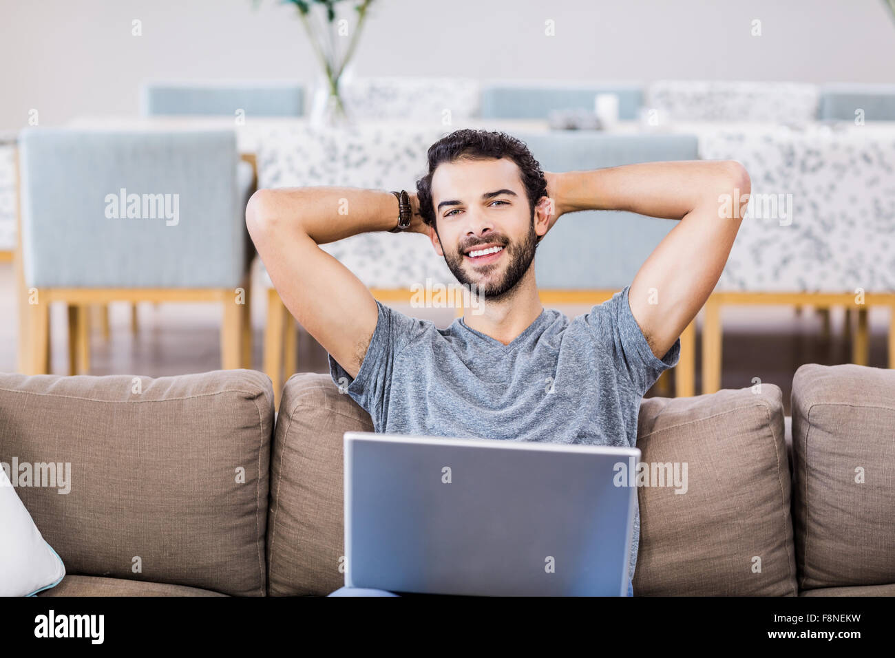 Handsome man relaxing on sofa Stock Photo - Alamy