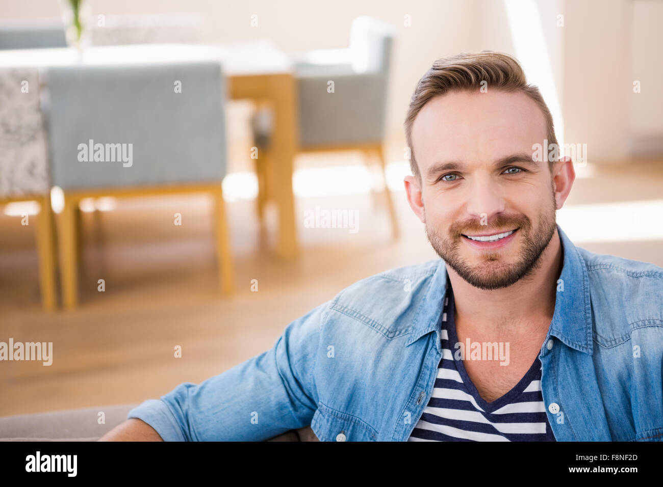 Handsome man smiling at camera Stock Photo - Alamy