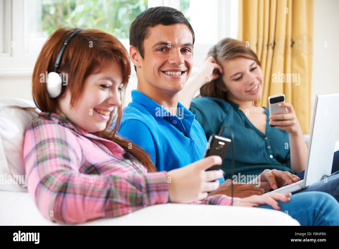 Teenage Friends Using Digital Technology At Home Stock Photo - Alamy