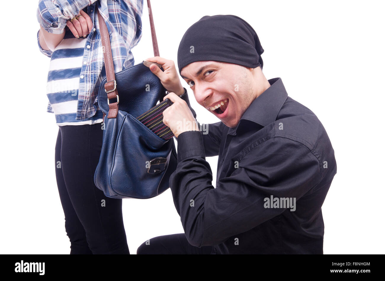 Young thief stealing woman's bag Stock Photo - Alamy