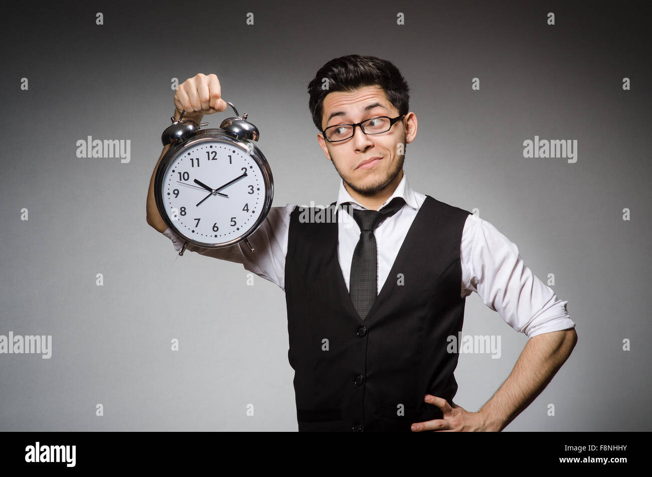 Businessman with clock in time concept Stock Photo - Alamy